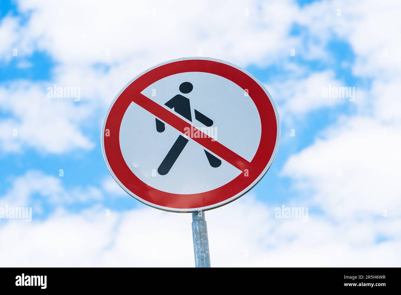A road sign indicating 'No Pedestrian Traffic' against a gray sky ...