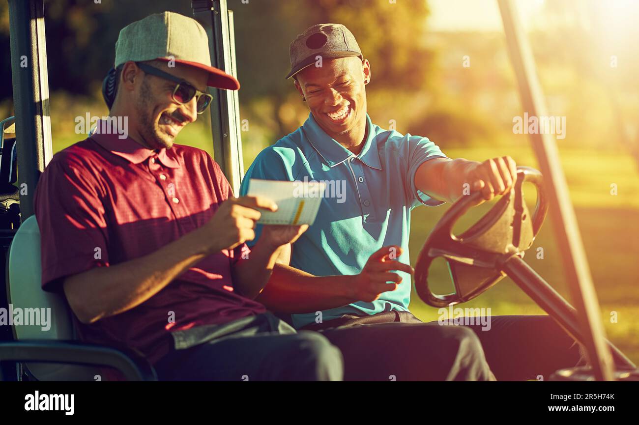 Living the life. two golfers riding in a cart on a golf course Stock ...
