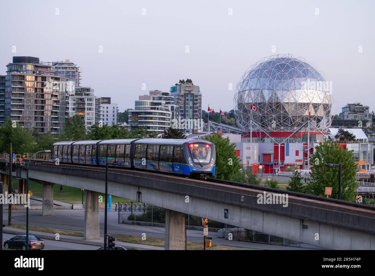 Skytrain riding by Science World during Sunn Sunset Stock Photo - Alamy
