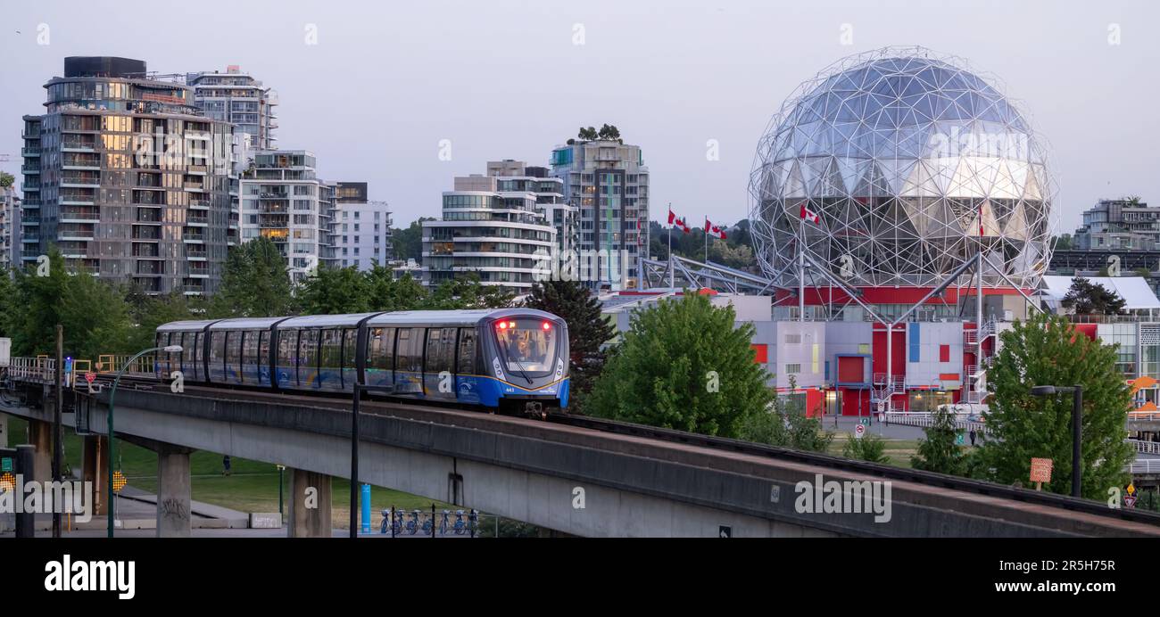 Skytrain riding by Science World during Sunn Sunset Stock Photo - Alamy