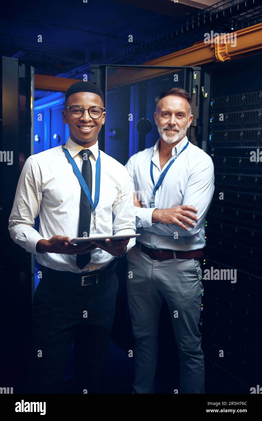 The IT experts. Portrait of two technicians using a digital tablet ...