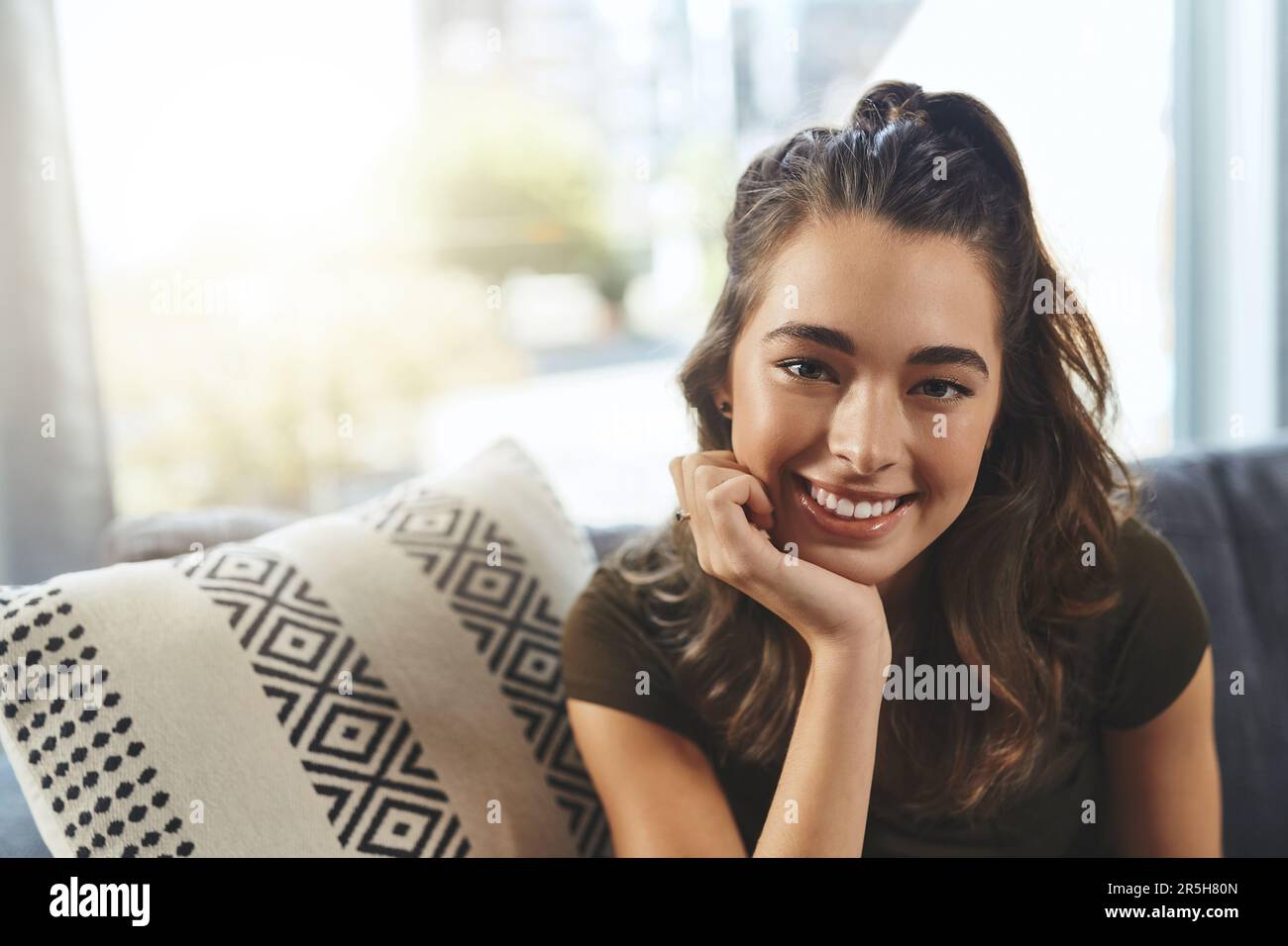Cherish every moment you spend alone. Portrait of a beautiful young woman relaxing on her sofa ...