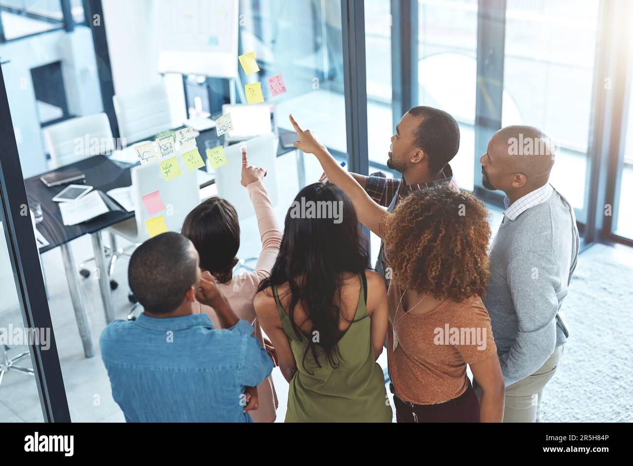 Asking the real questions. High angle shot of a group of coworkers ...