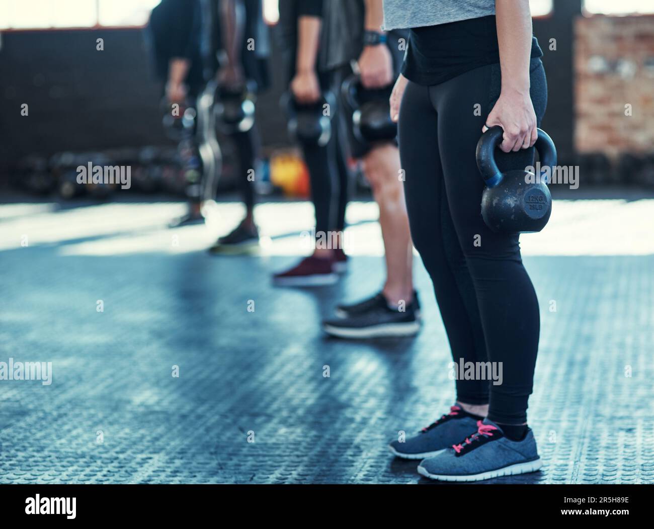 Weights for strength. a group unrecognizable people standing in a row ...