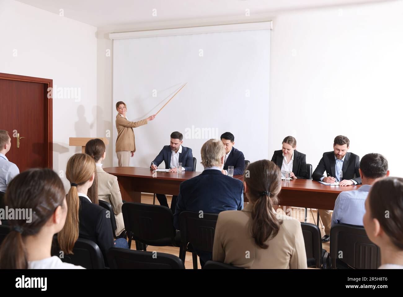 Business conference. People in meeting room listening to speaker report ...