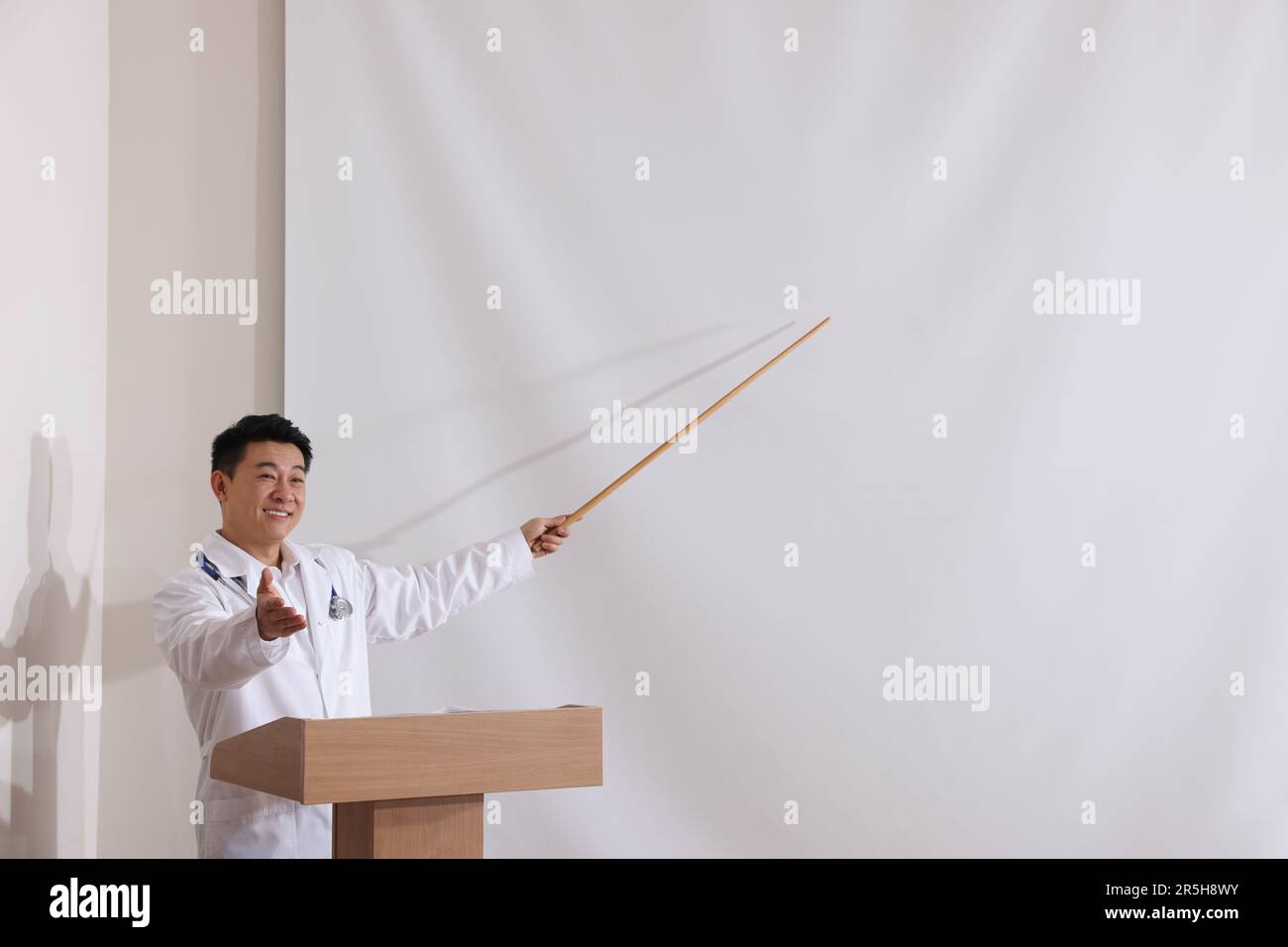 Doctor giving lecture in conference room with projection screen Stock ...