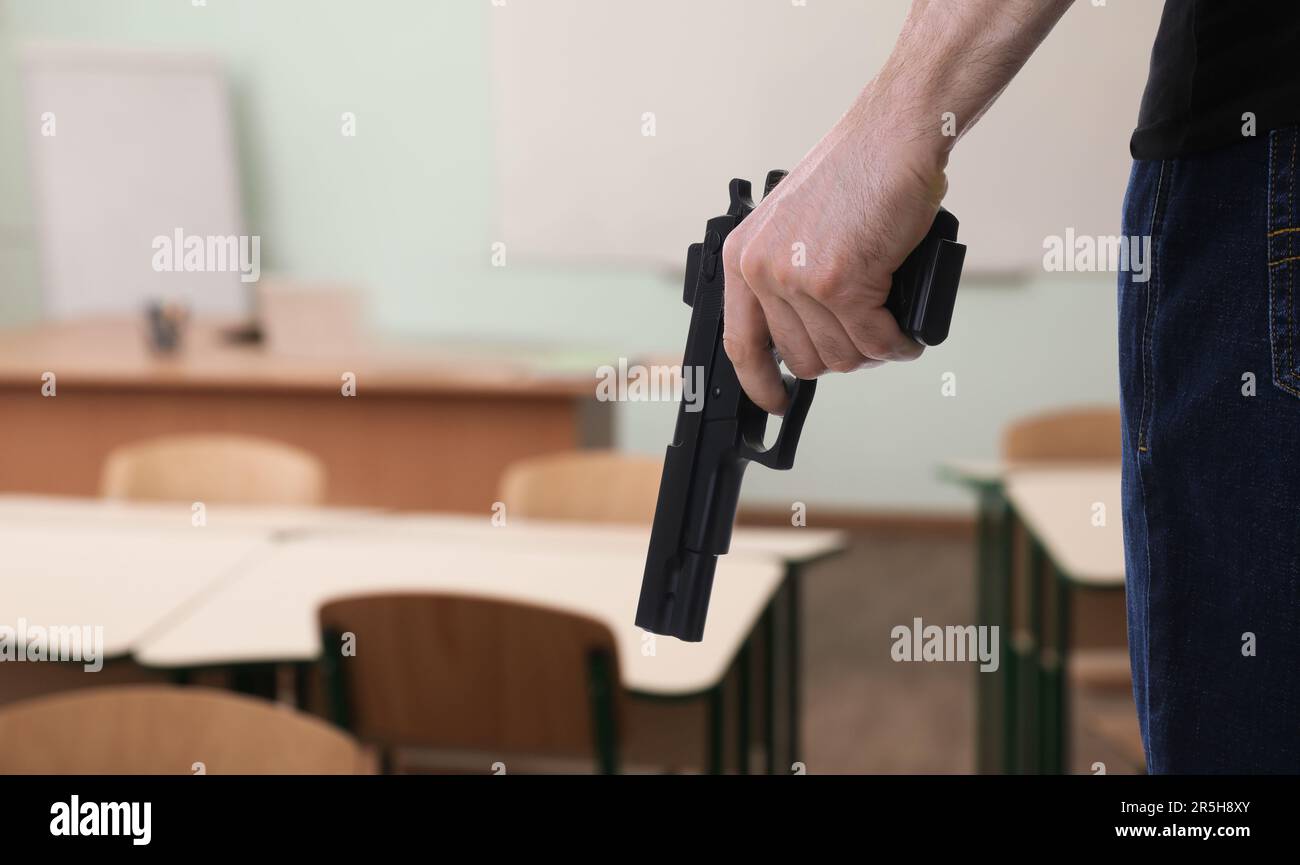 School shooting. Man with gun in classroom, closeup Stock Photo - Alamy