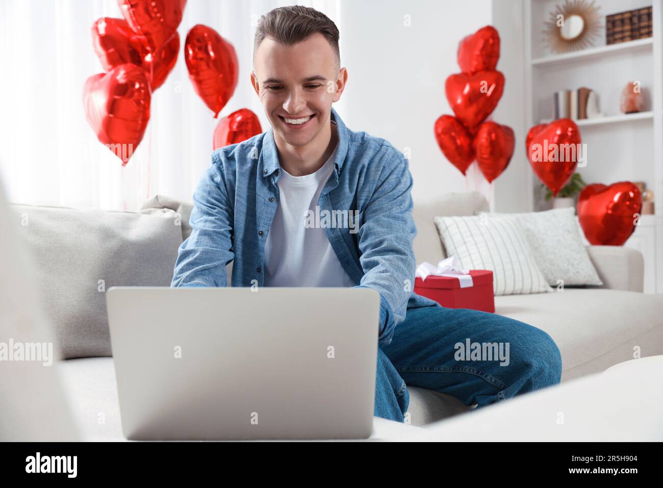 Valentine's day celebration in long distance relationship. Man chatting ...