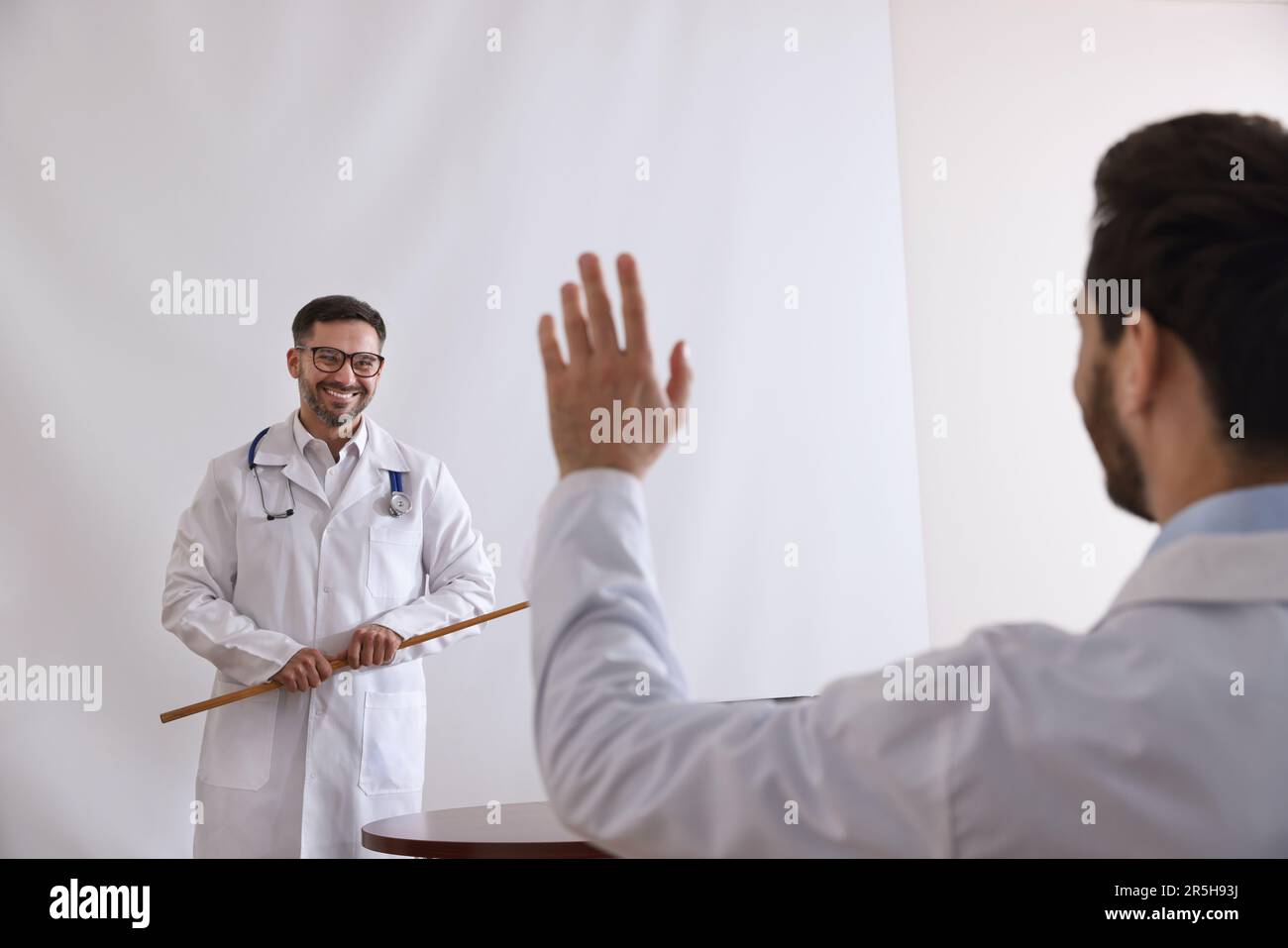 Doctor giving lecture in conference room with projection screen Stock ...