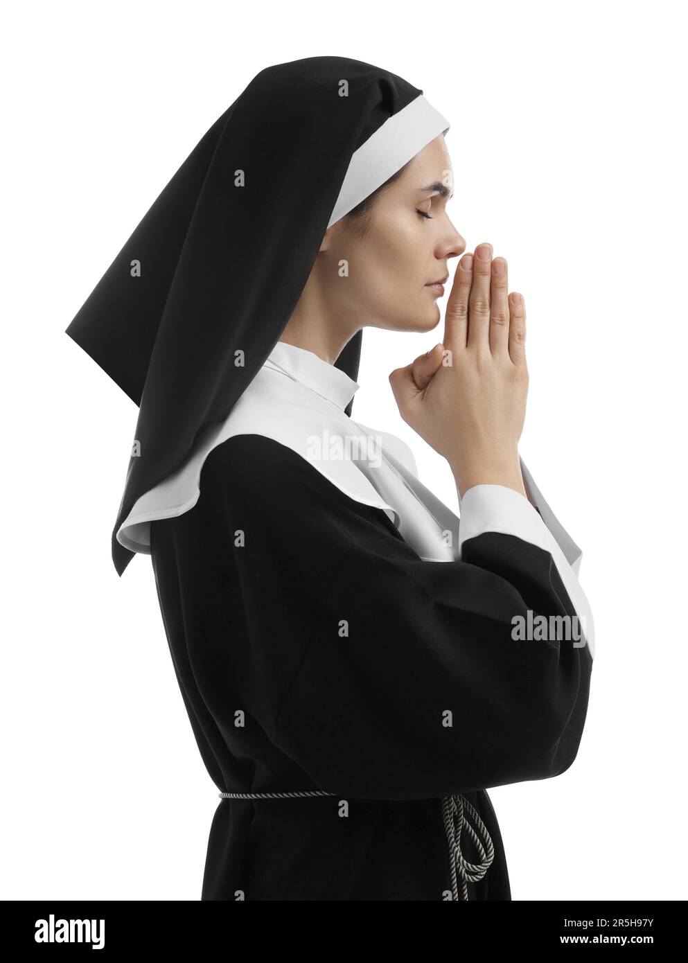 Nun with clasped hands praying to God on white background Stock Photo ...