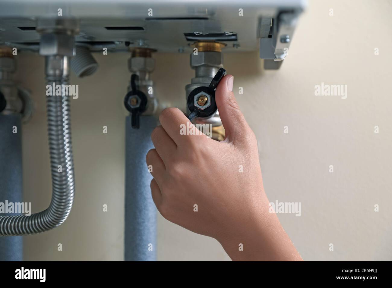 Woman turning on gas hi-res stock photography and images - Alamy