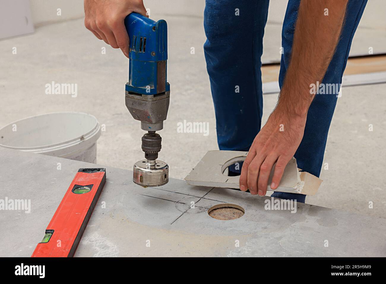 Worker making socket hole in tile indoors, closeup Stock Photo - Alamy