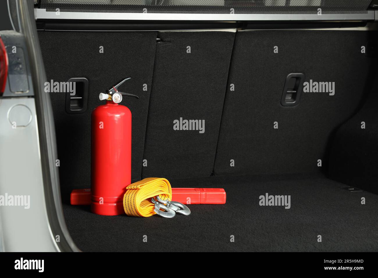 Red fire extinguisher, towing strap and foldable emergency warning ...