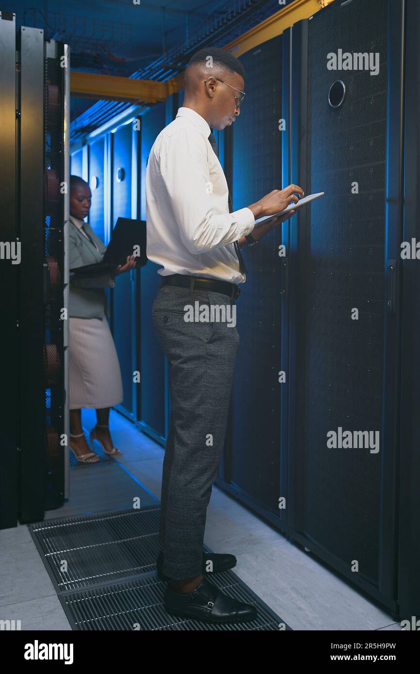 Strengthening the firewall. two young IT specialists standing together ...