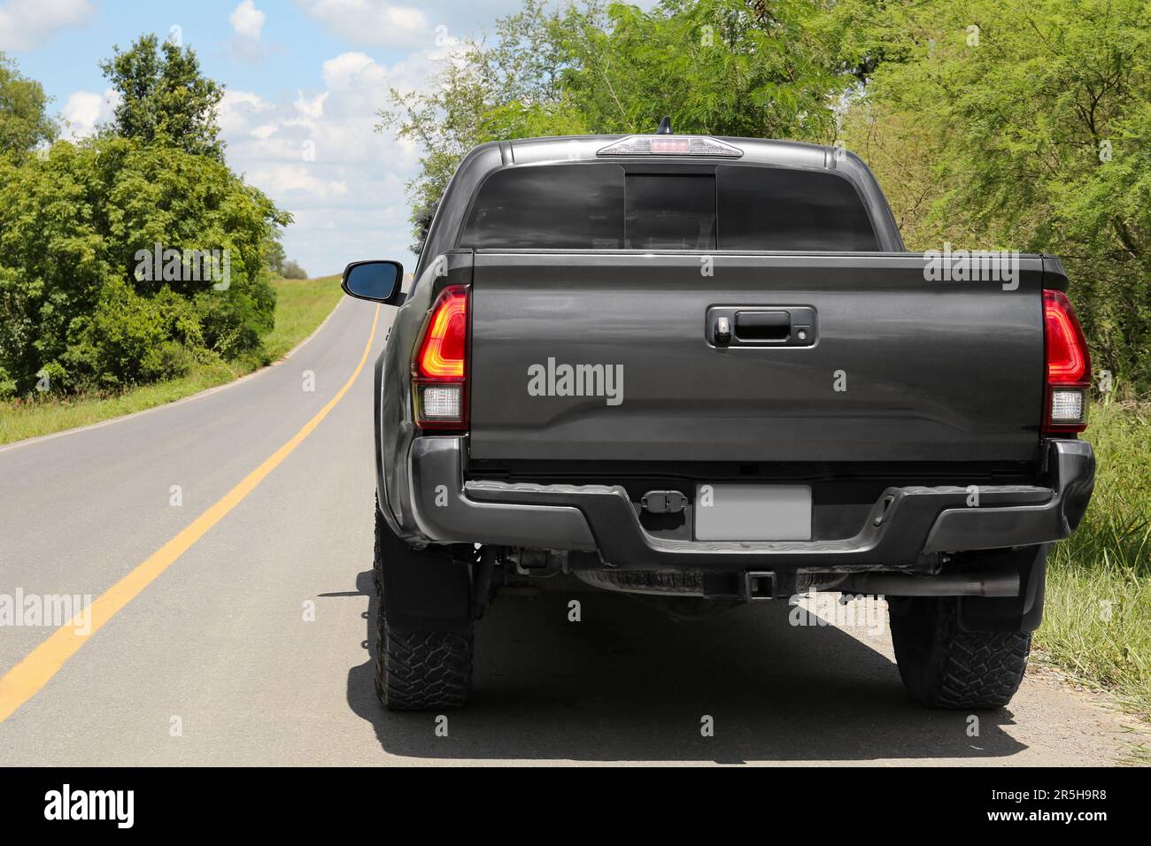 Car driving on asphalt road near trees Stock Photo - Alamy