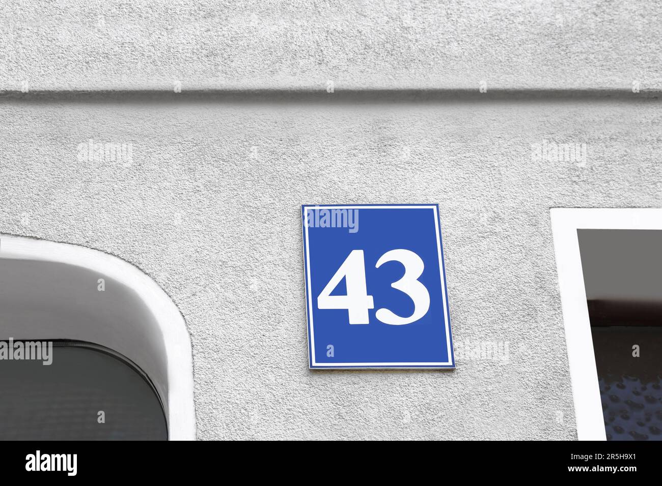 Plate with house number fourty three on light grey wall outdoors Stock ...