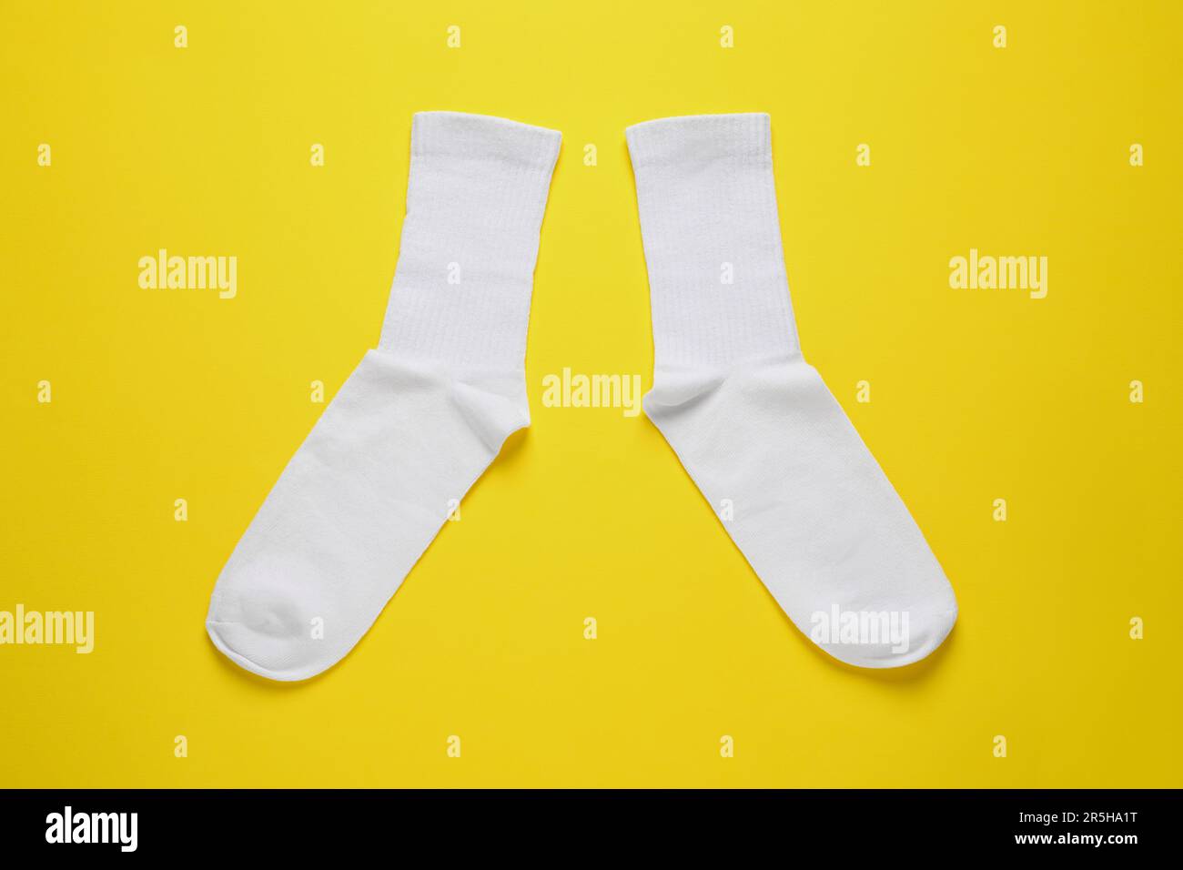 Pair of white socks on yellow background, flat lay Stock Photo - Alamy