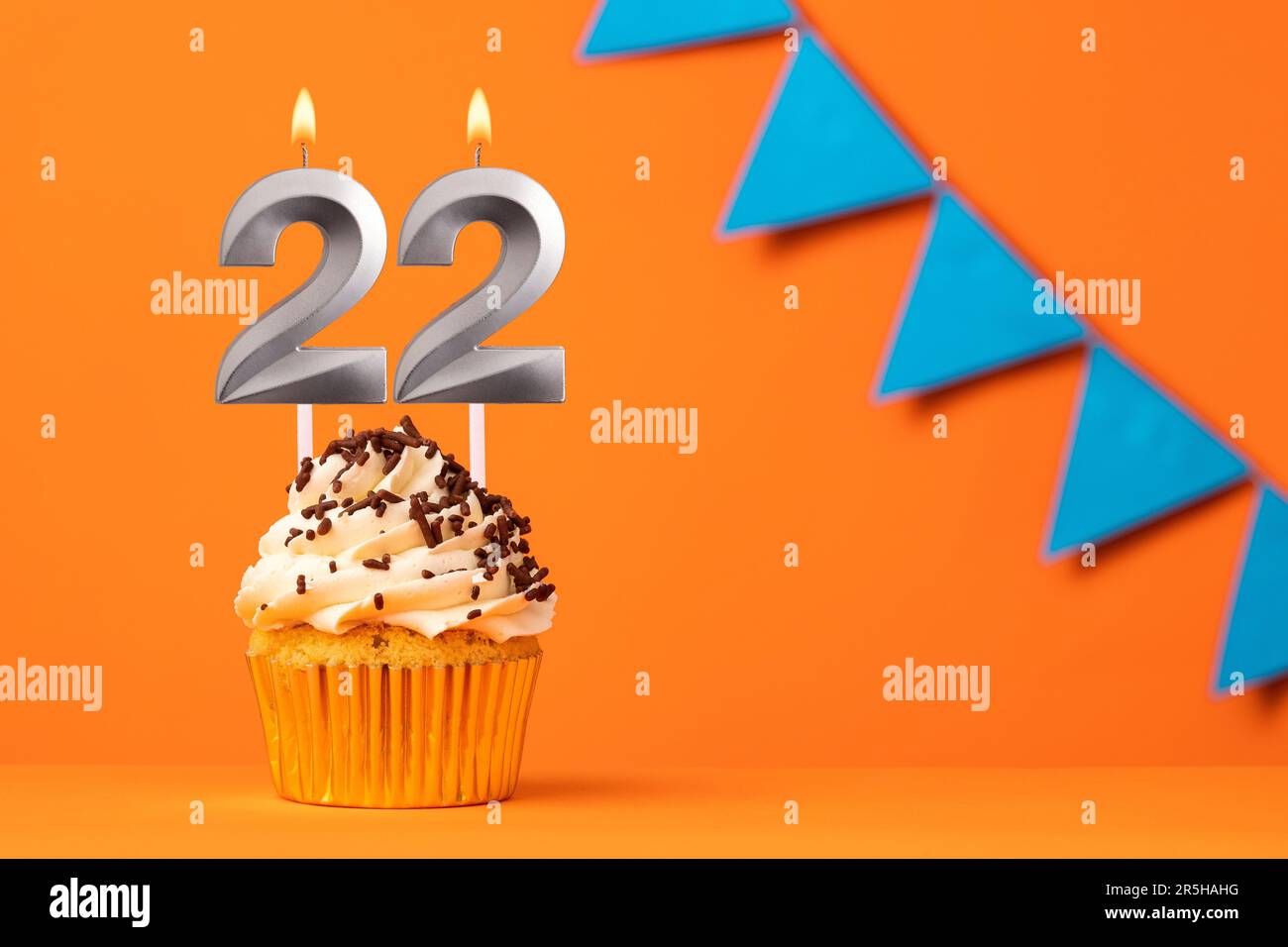 Birthday cake with candle number 22 - Orange background Stock Photo - Alamy