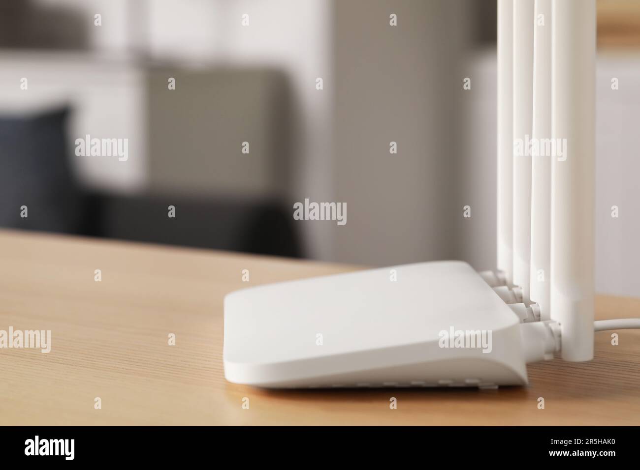New white Wi-Fi router on wooden table indoors. Space for text Stock Photo - Alamy