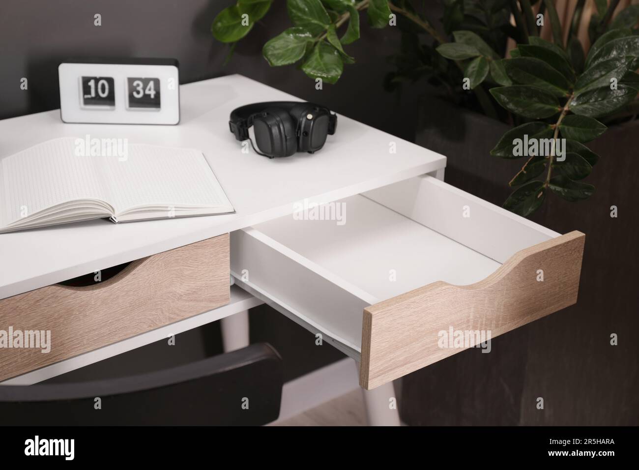 Stylish desk with open empty drawer in office Stock Photo - Alamy