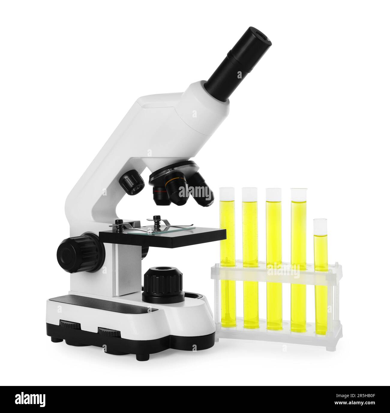 Test tubes with yellow liquid and microscope isolated on white Stock ...