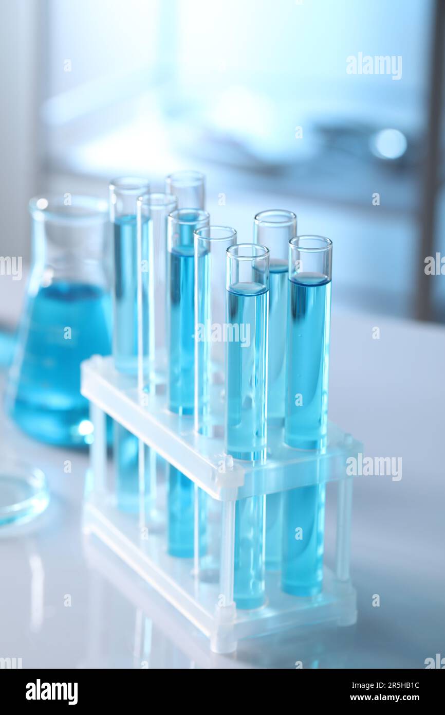 Test tubes with light blue liquid in laboratory, closeup Stock Photo ...