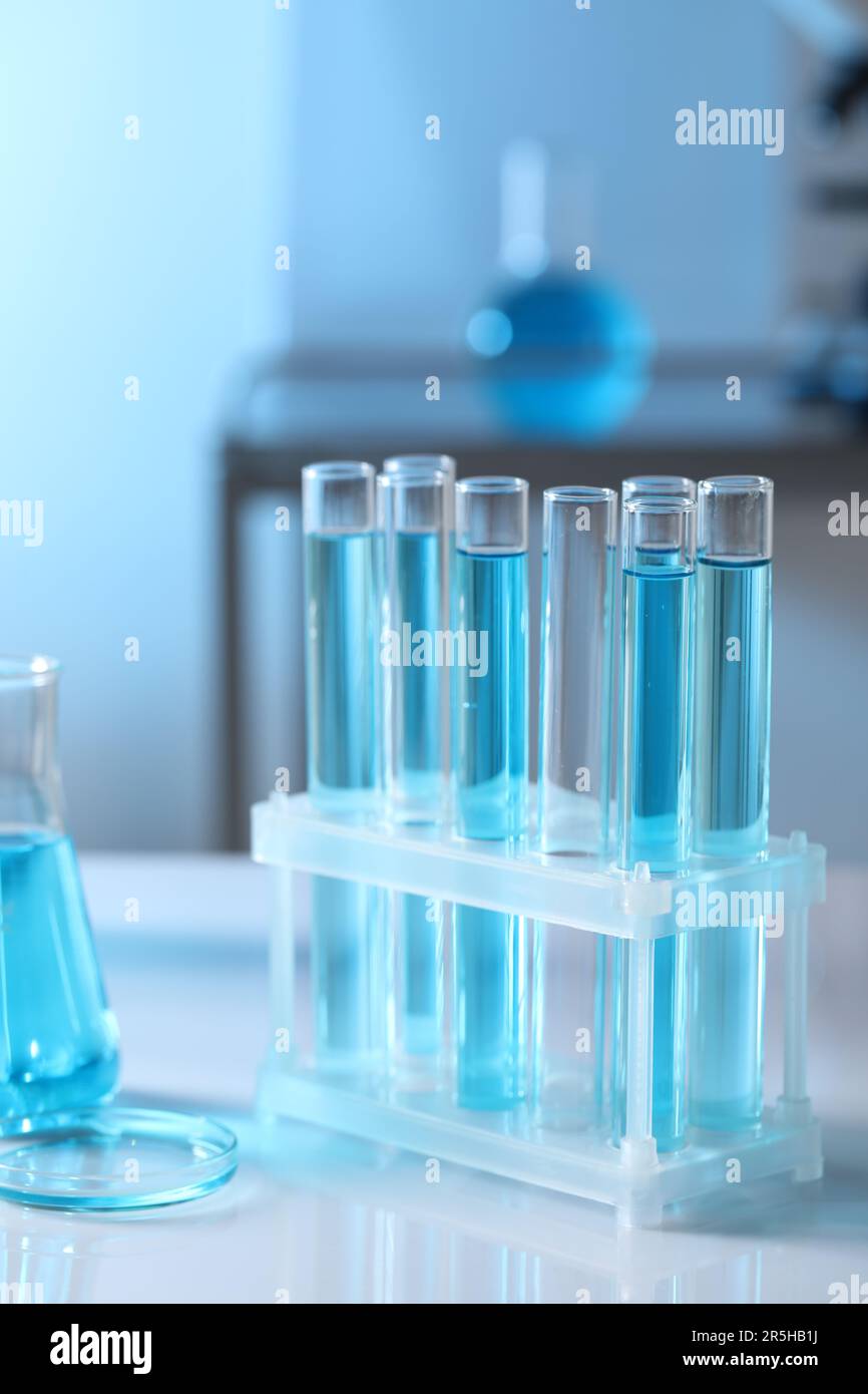 Test tubes with light blue liquid in laboratory, closeup Stock Photo ...