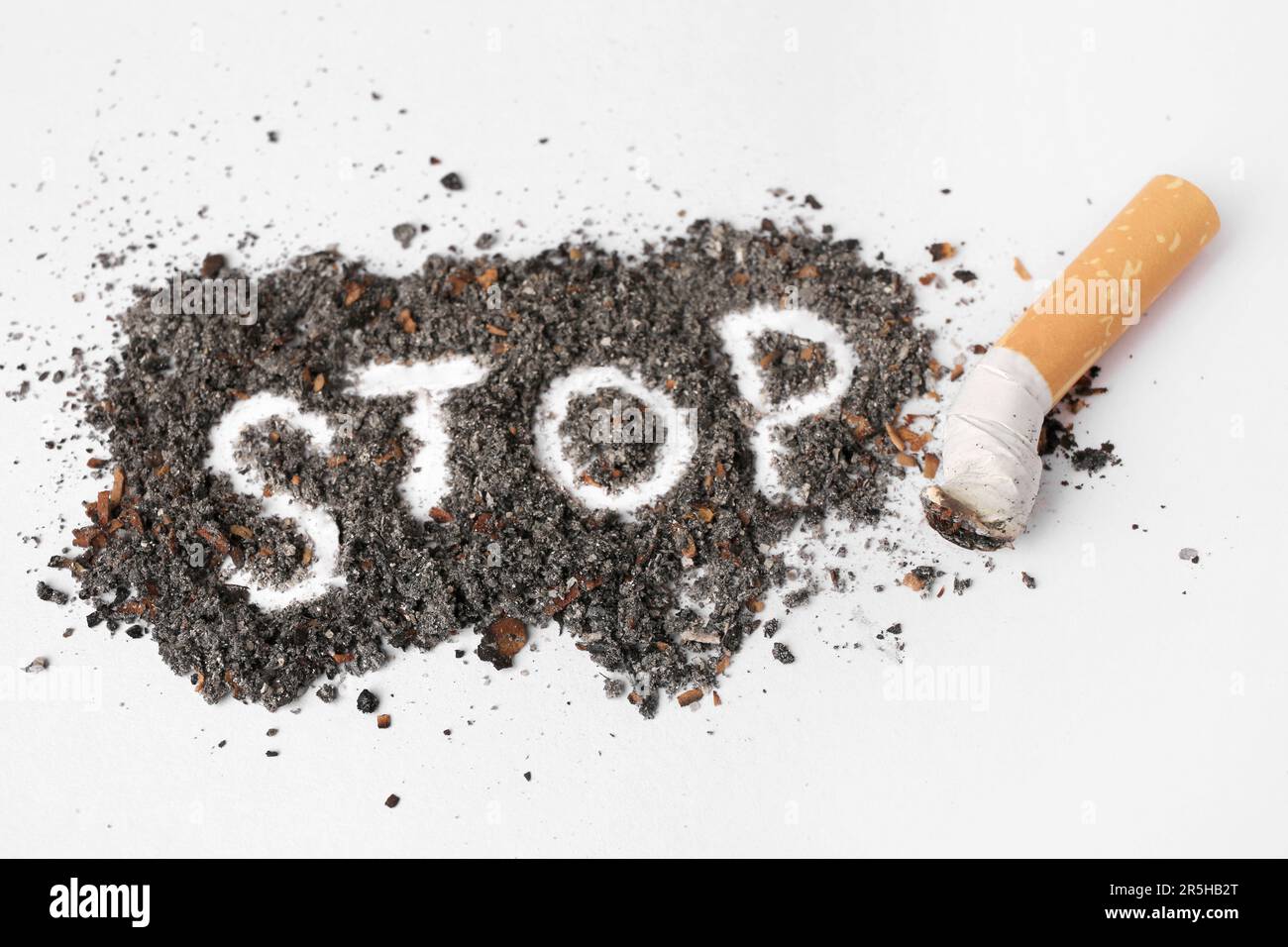 Word Stop made of cigarette ash and stub on white background, closeup ...