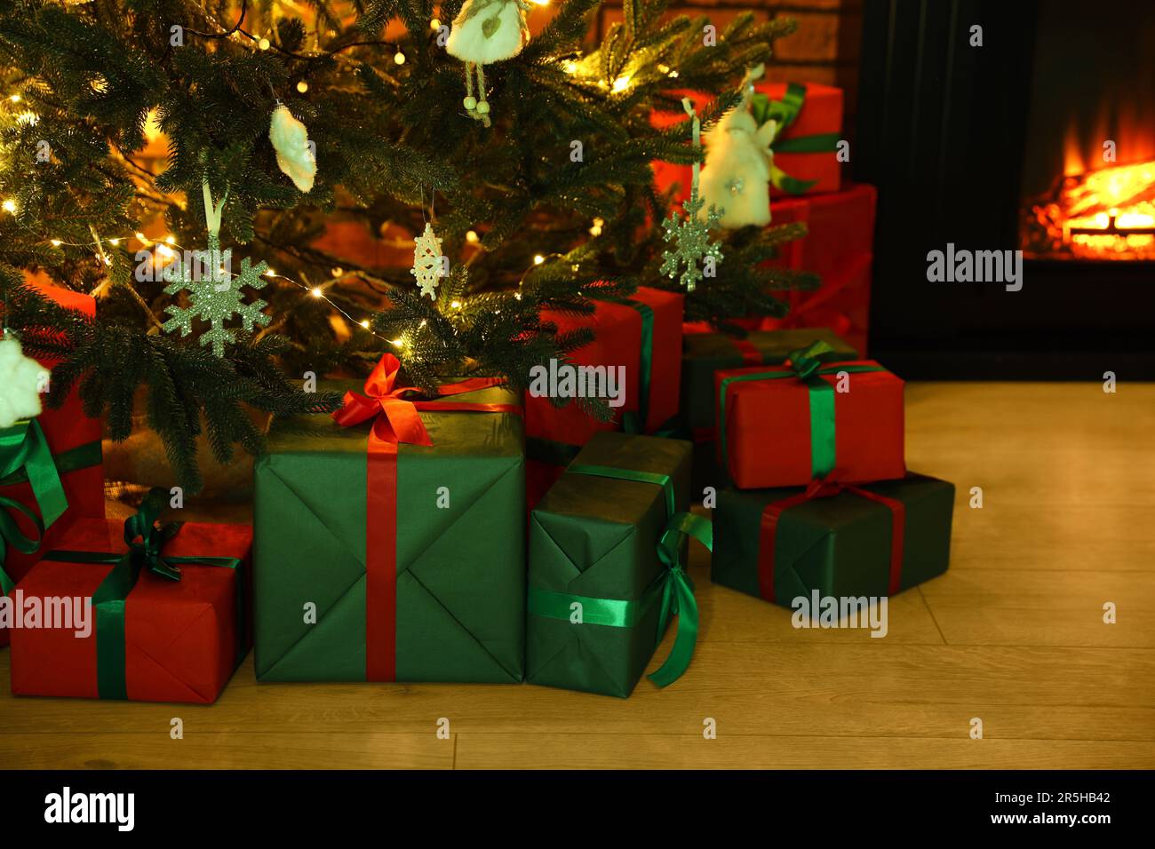 Beautifully wrapped gift boxes under Christmas tree indoors Stock Photo ...