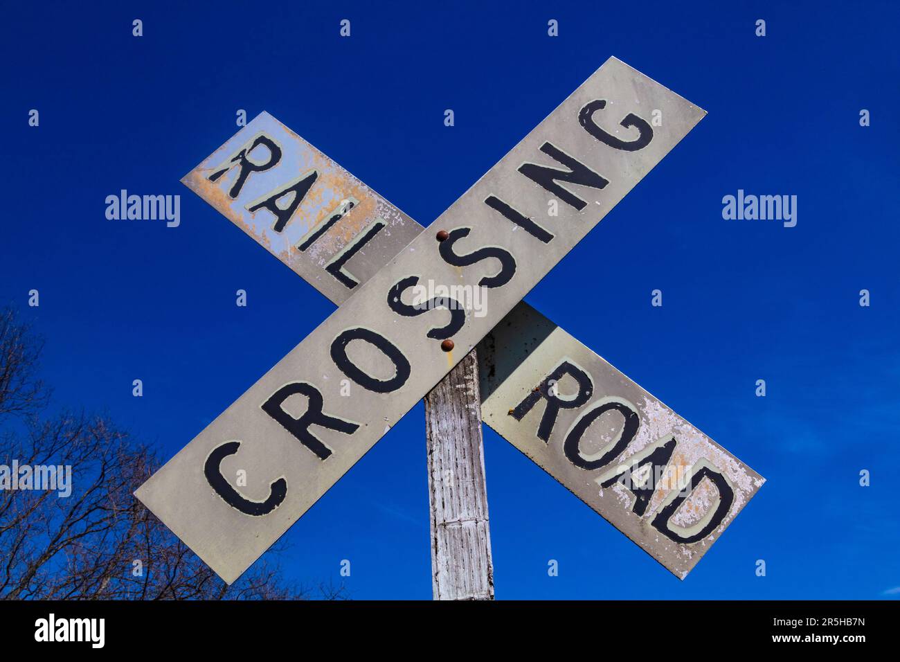 Old Railroad Crossing Sign Against Blue Sky Stock Photo - Alamy