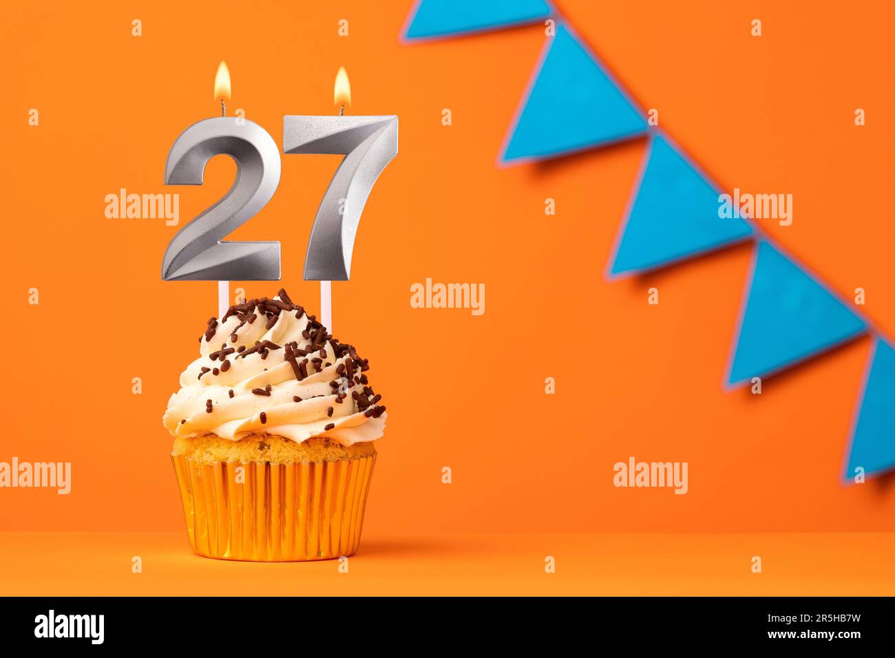 Candle number 27 - Cake birthday in orange background Stock Photo - Alamy