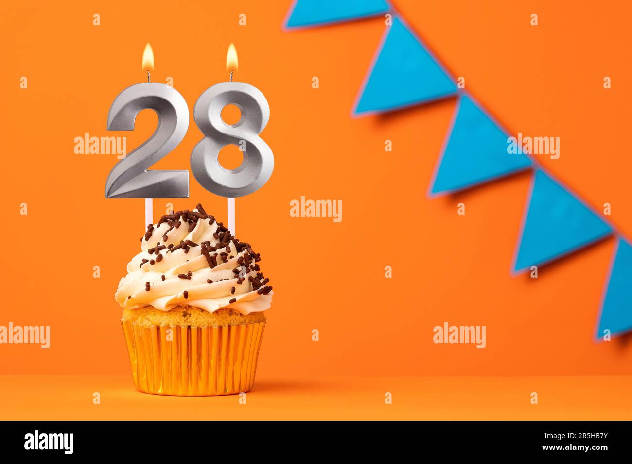 Birthday cake with candle number 28 - Orange background Stock Photo - Alamy