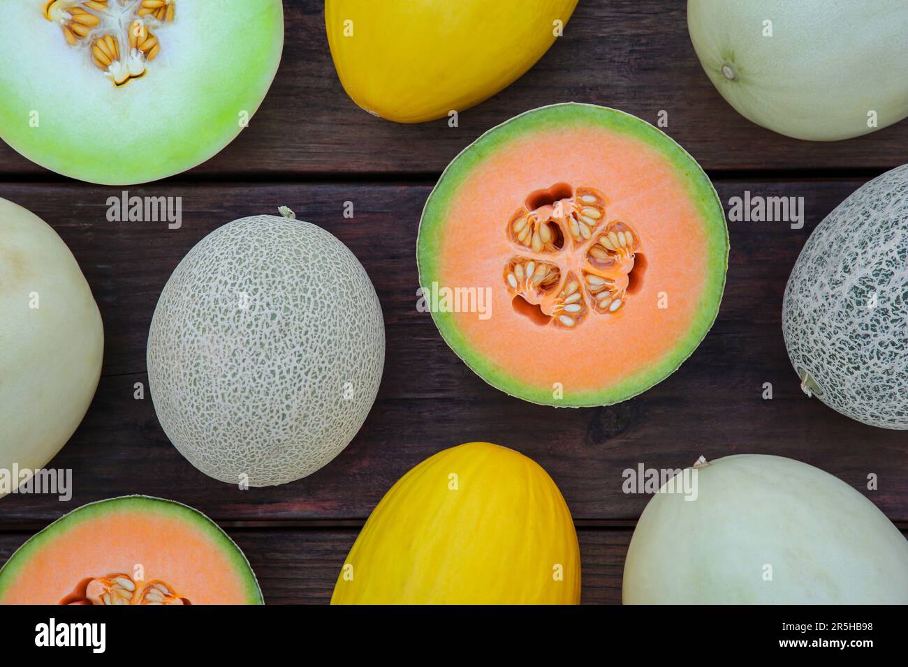 Different types of tasty ripe melons on wooden table, flat lay Stock ...