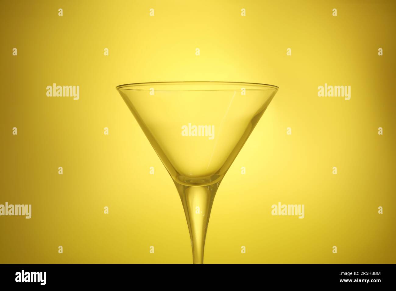 Elegant empty martini glass on yellow background, closeup Stock Photo - Alamy