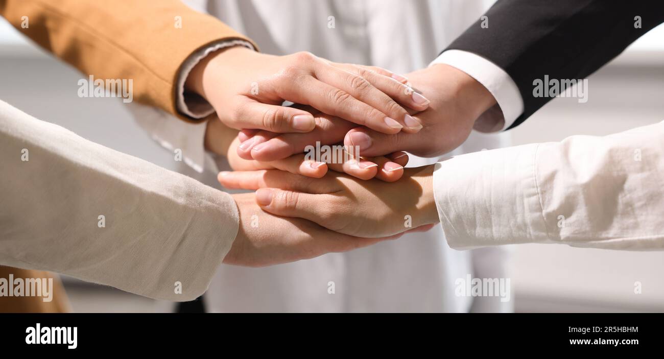 Business partners. Group of people holding hands together in office ...