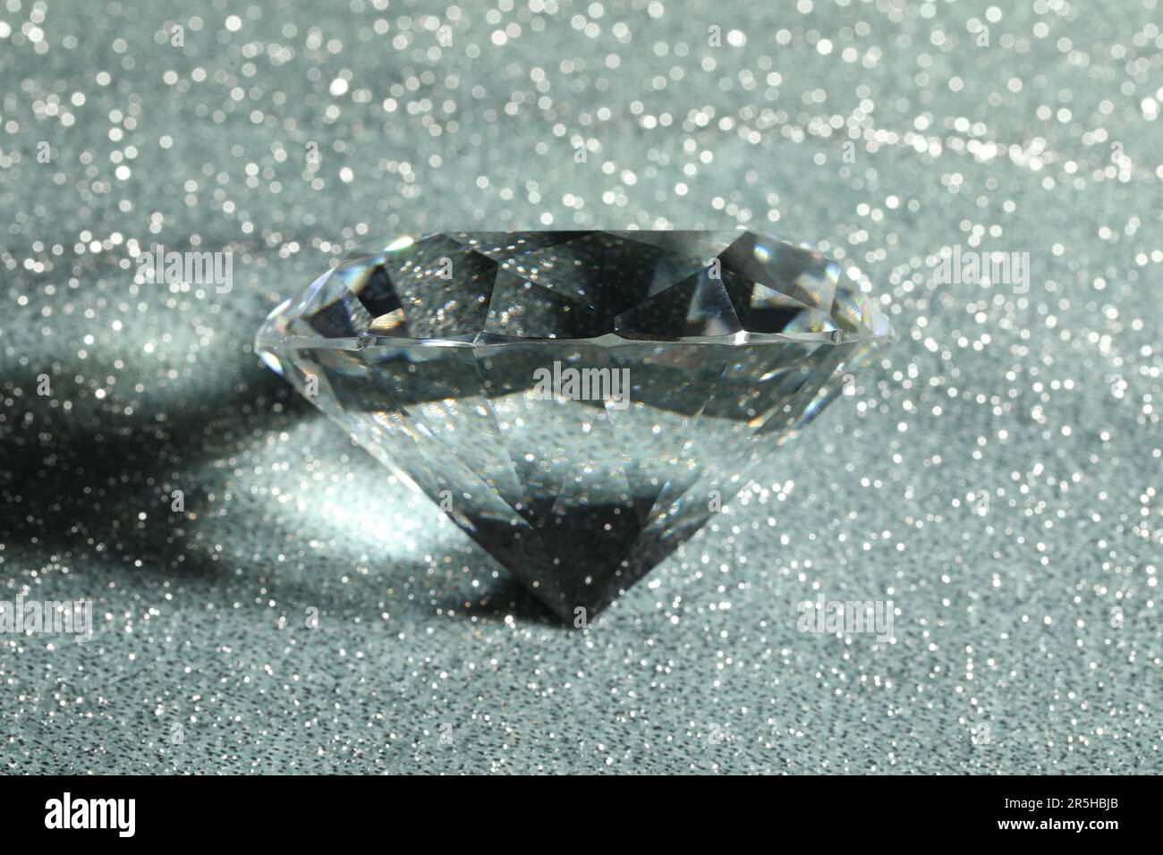 Beautiful dazzling diamond on silver glitter background, closeup Stock ...