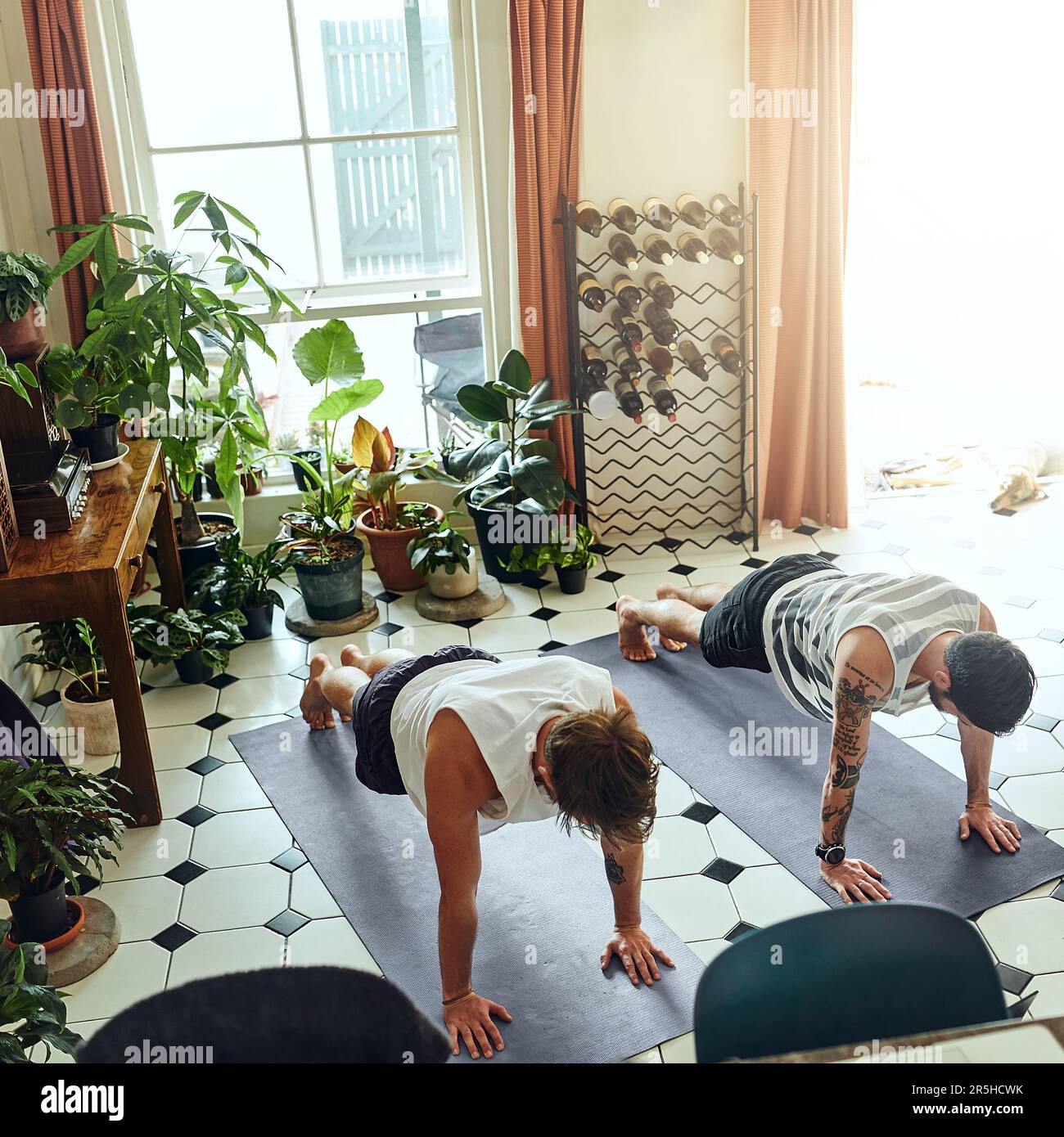 Everyday should be yoga day. two young men doing planks during a yoga ...