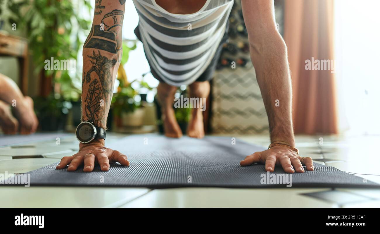 Arm yourself with good health. an unrecognisable young man doing planks ...