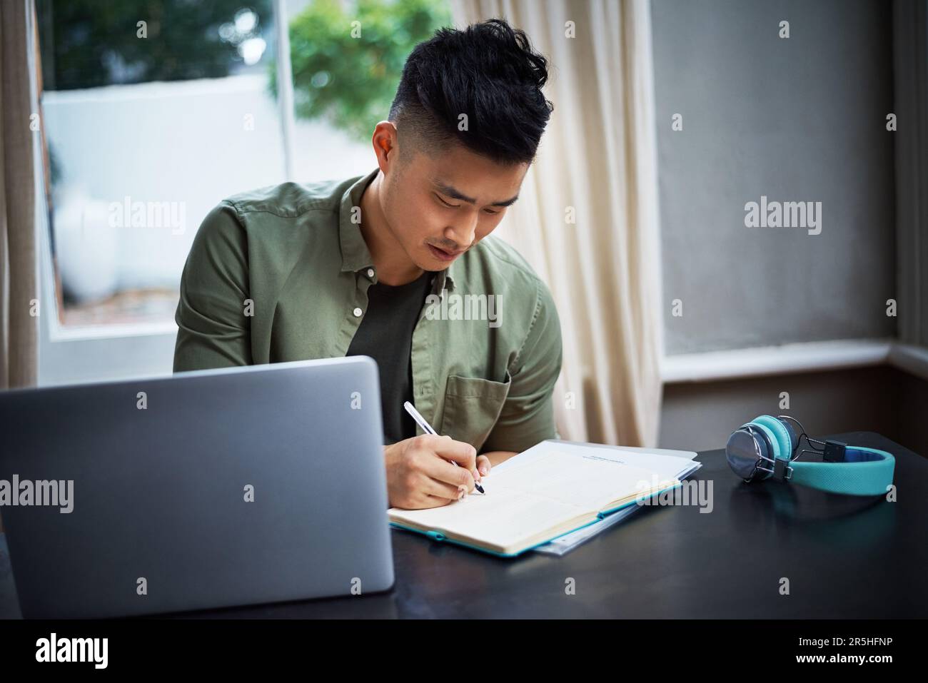 Working according to the design brief. a handsome young man taking ...