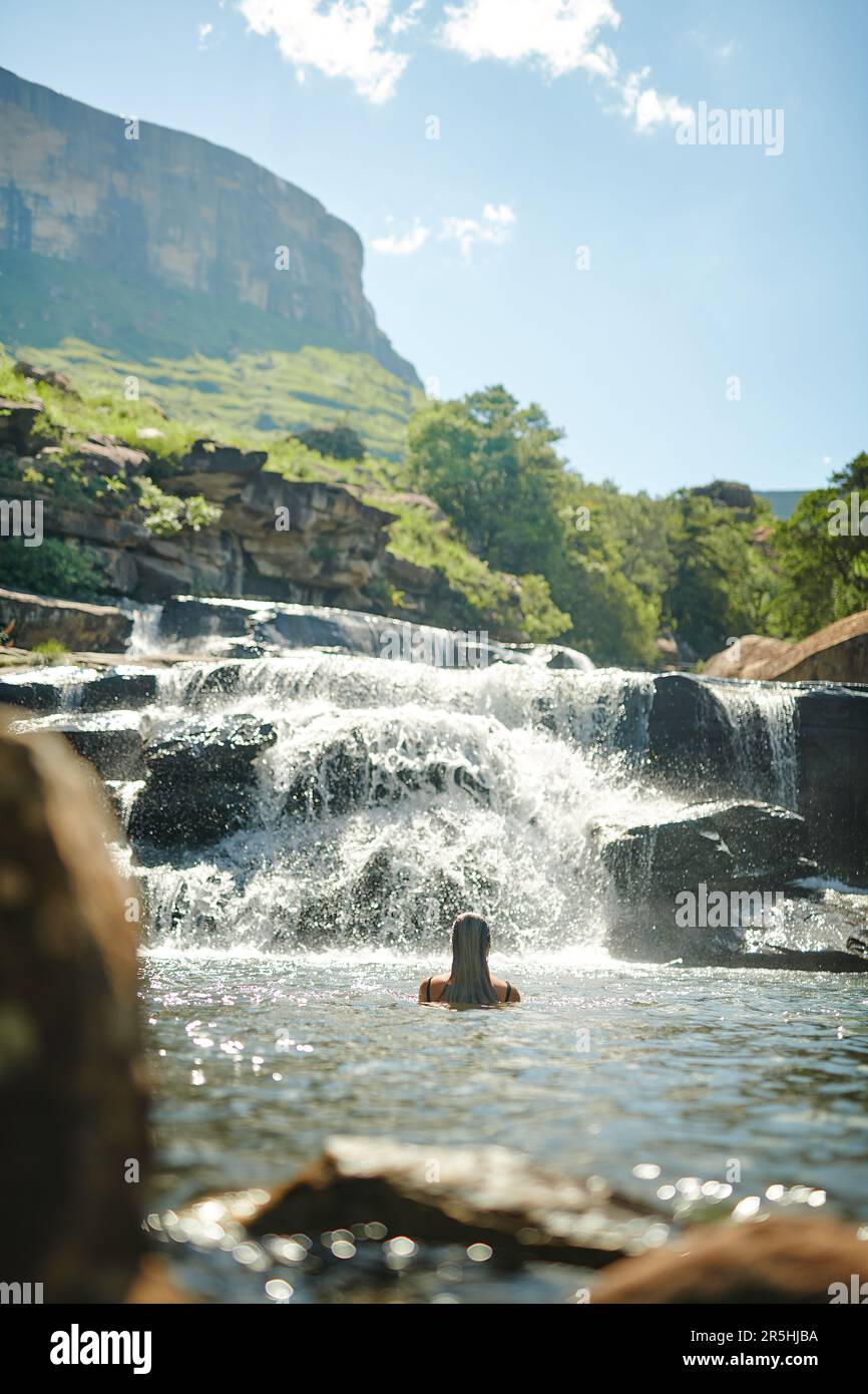 Getting lost in mother nature. an unrecognizable woman swimming in a ...