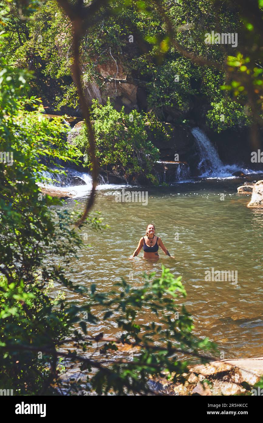 Enjoying some downtime. an attractive young woman swimming in a stream ...