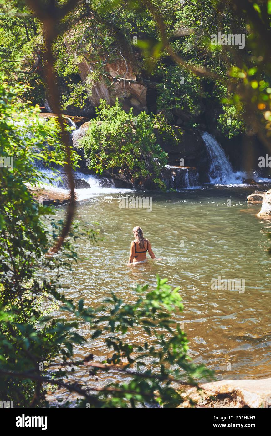 Let me stay here all day. an unrecognizable woman swimming in a stream ...