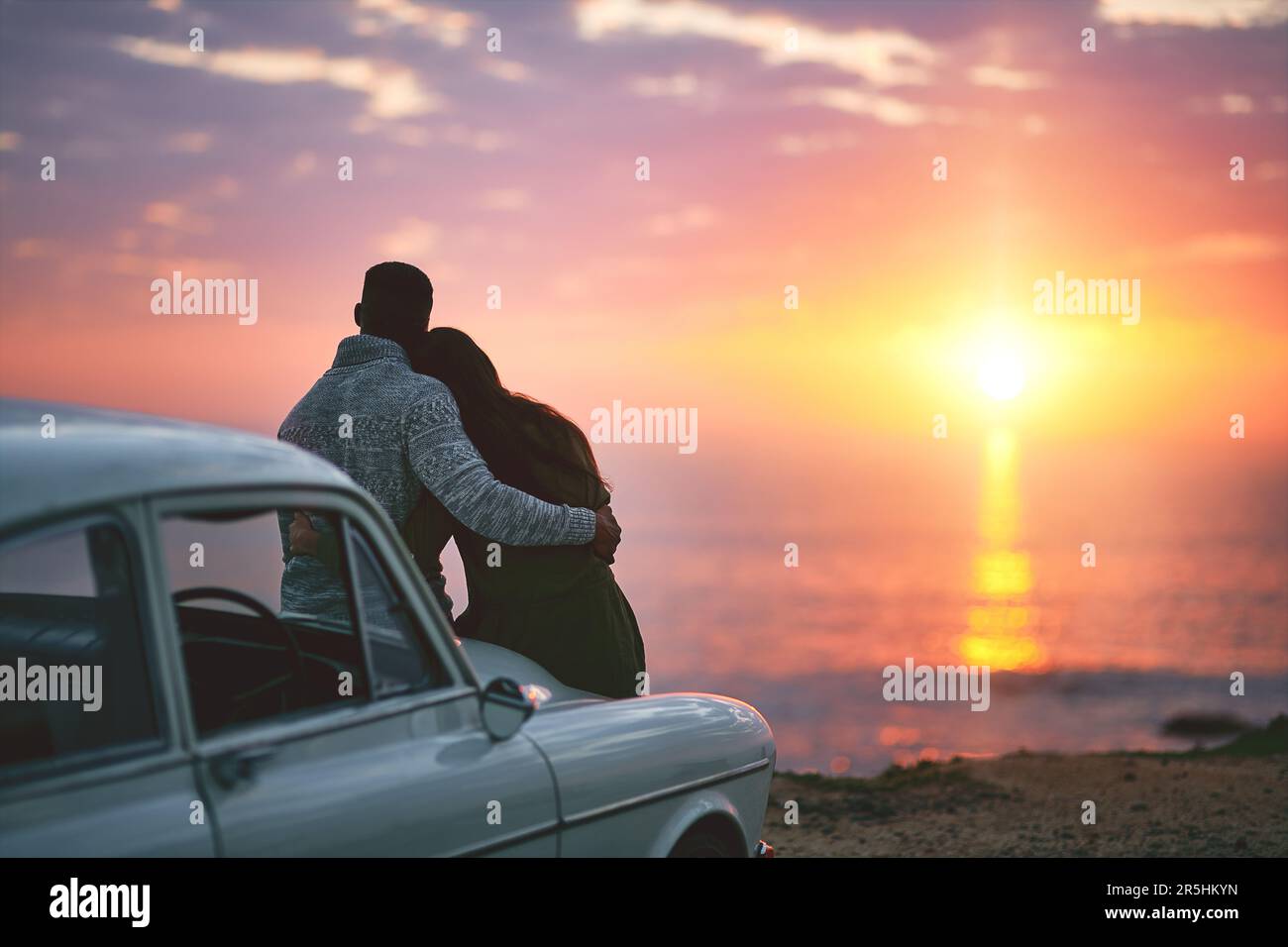 Watching the sun sunk into the sea. a young couple making a stop at the ...
