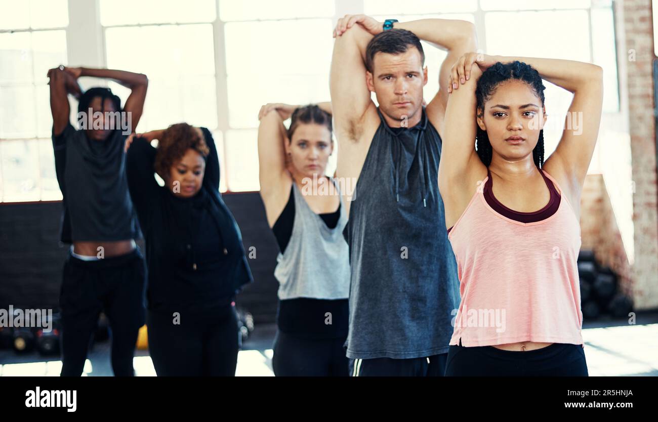 Everybody together now. a focused group of young people standing in a ...