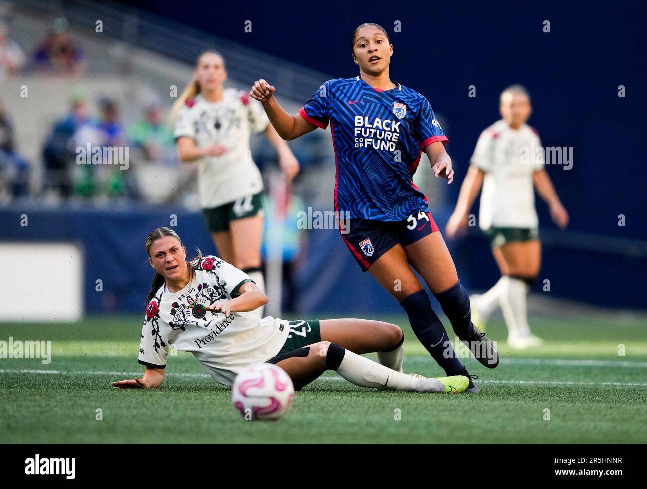 OL Reign forward Elyse Bennett (34) looks to regain control of the ball ...