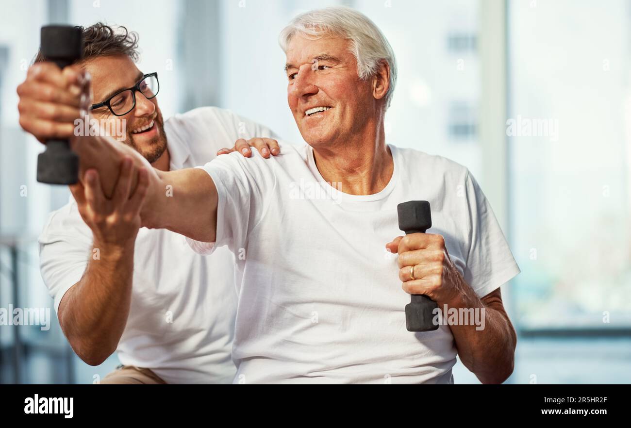 Youre doing great. a senior man working on his recovery with a male ...