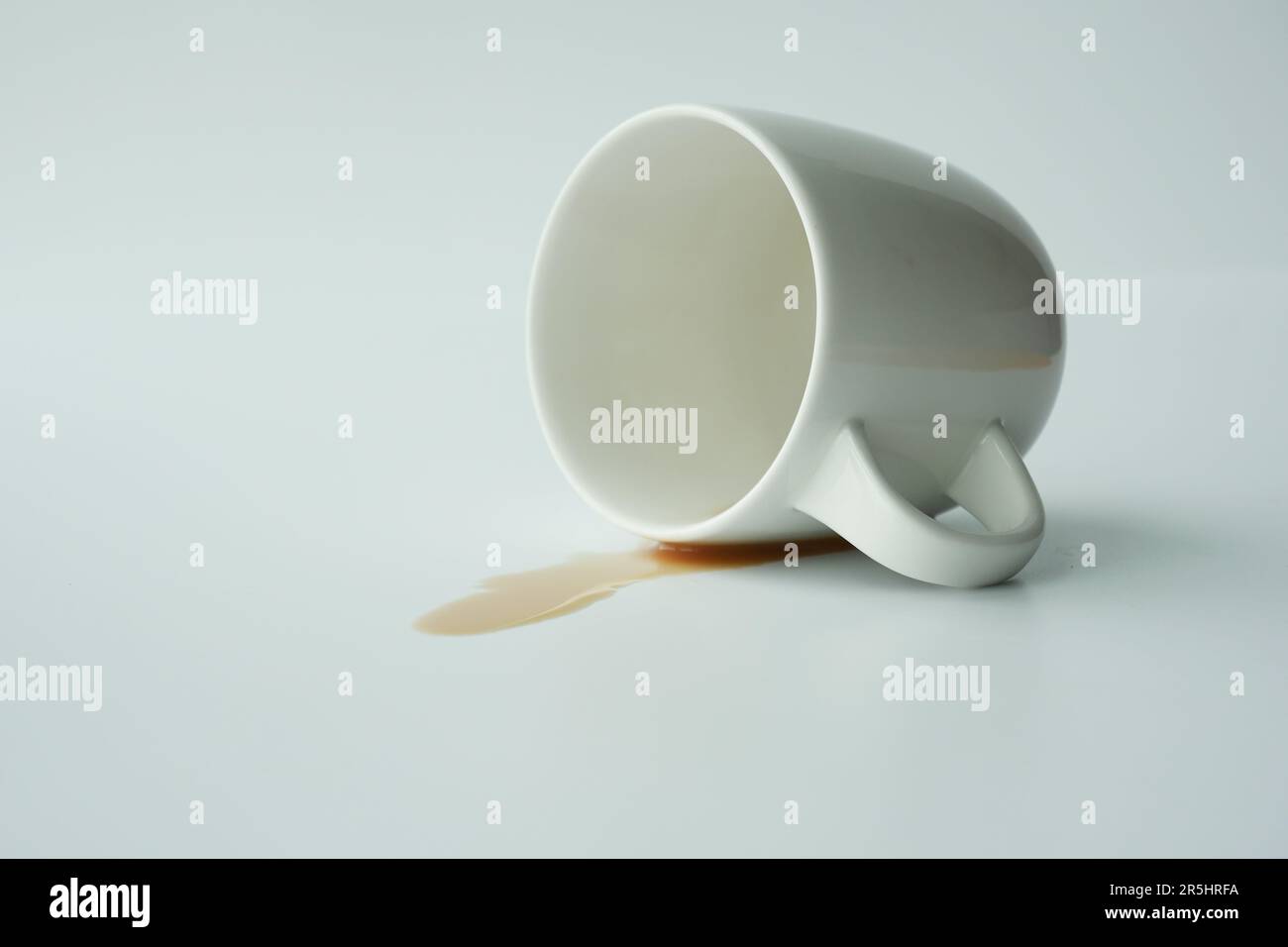 cup of coffee spilled on white background Stock Photo - Alamy