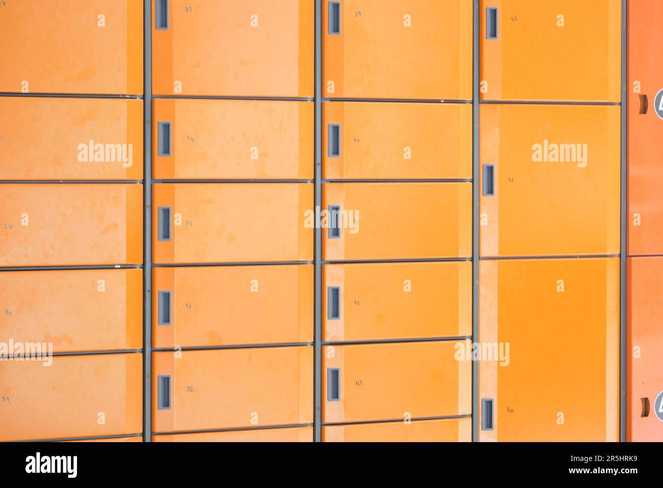 orange color storage box in public place. safe storage locker for ...