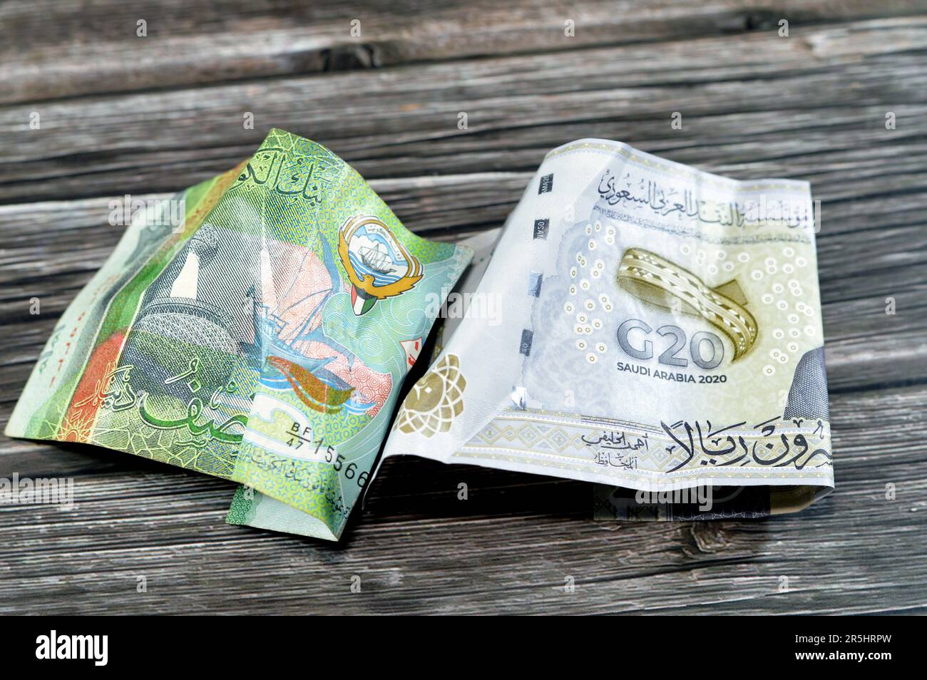 crumpled Kuwaiti and Saudi money of Half KWD Kuwait dinar and 20 SAR ...