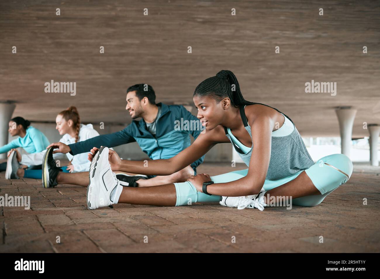Group, training and friends stretching as a fitness club for sports ...